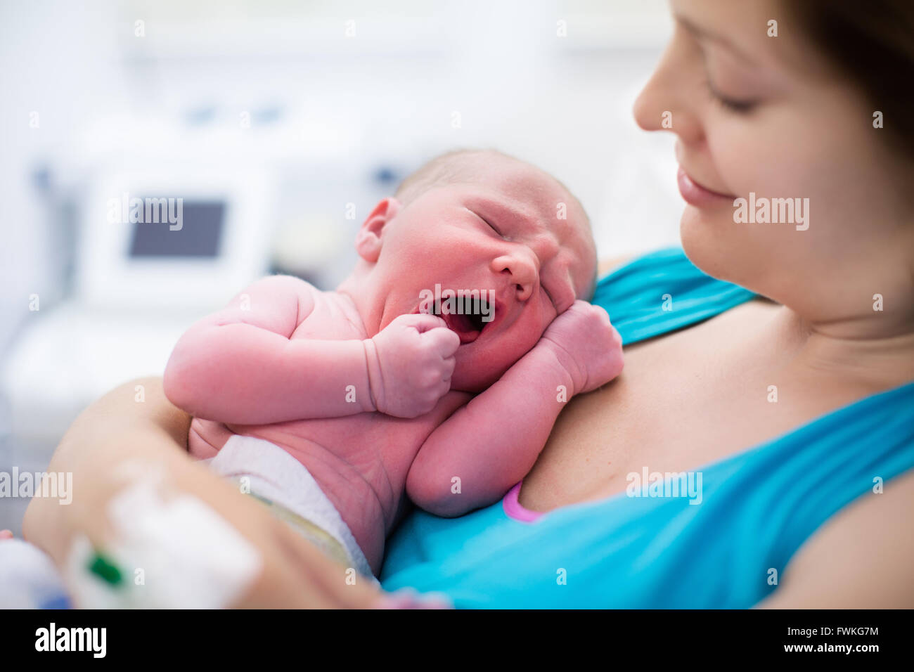 Mother giving birth to a baby. Newborn baby in delivery room. Mom ...