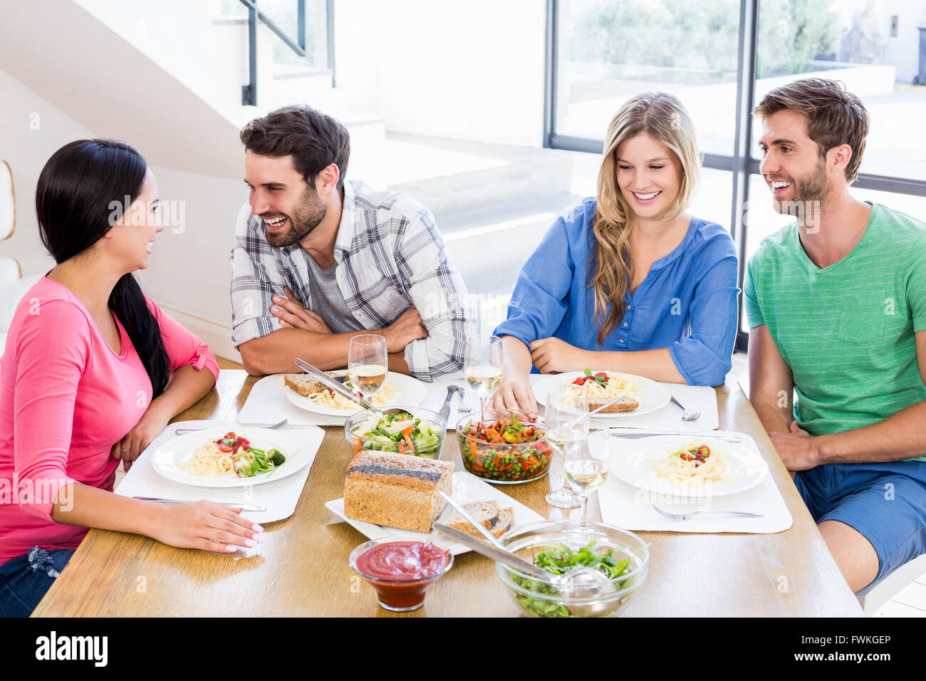 Friends interacting while having a meal Stock Photo - Alamy