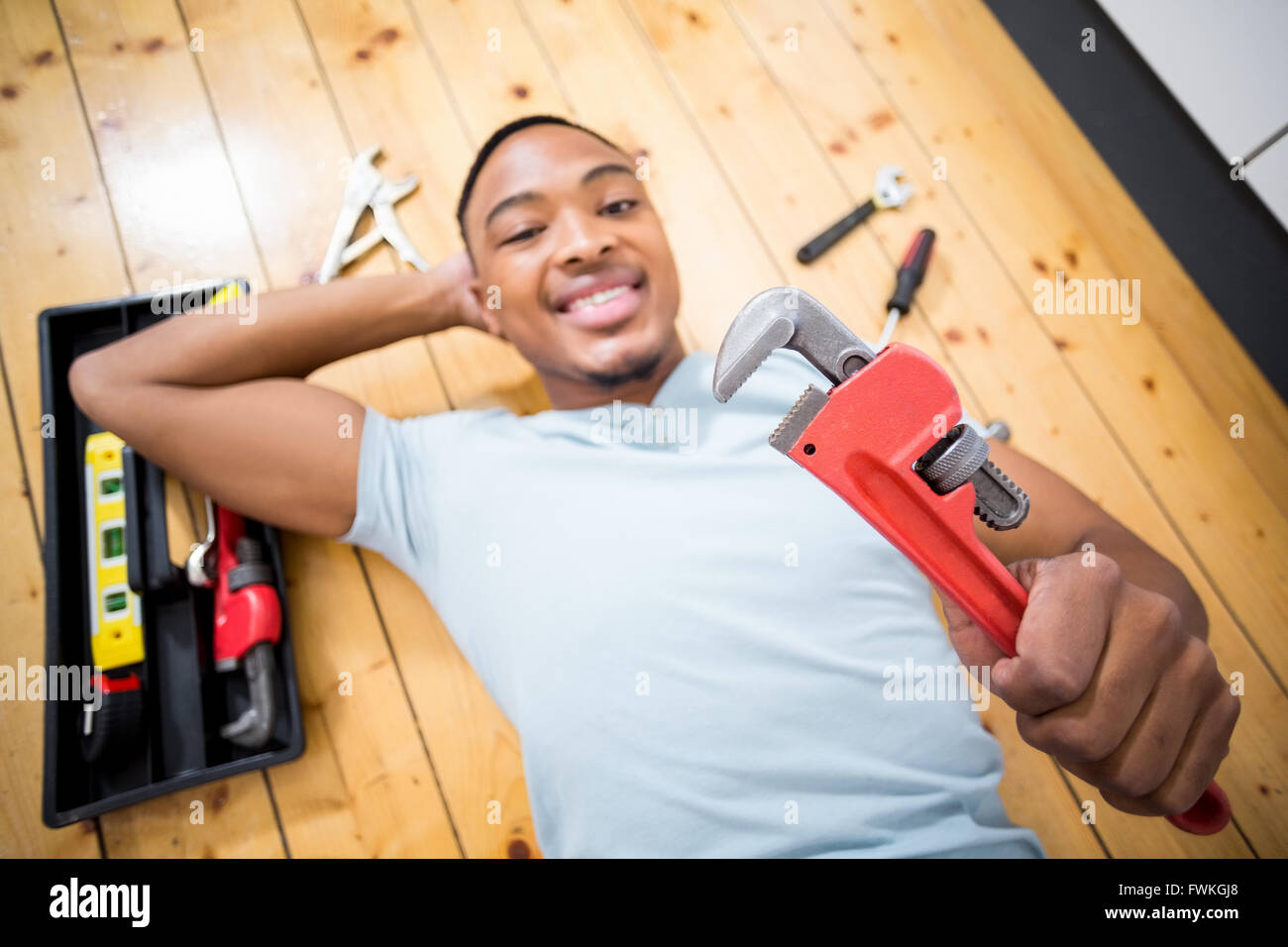Man showing a wrench while working with a set of tools Stock Photo - Alamy