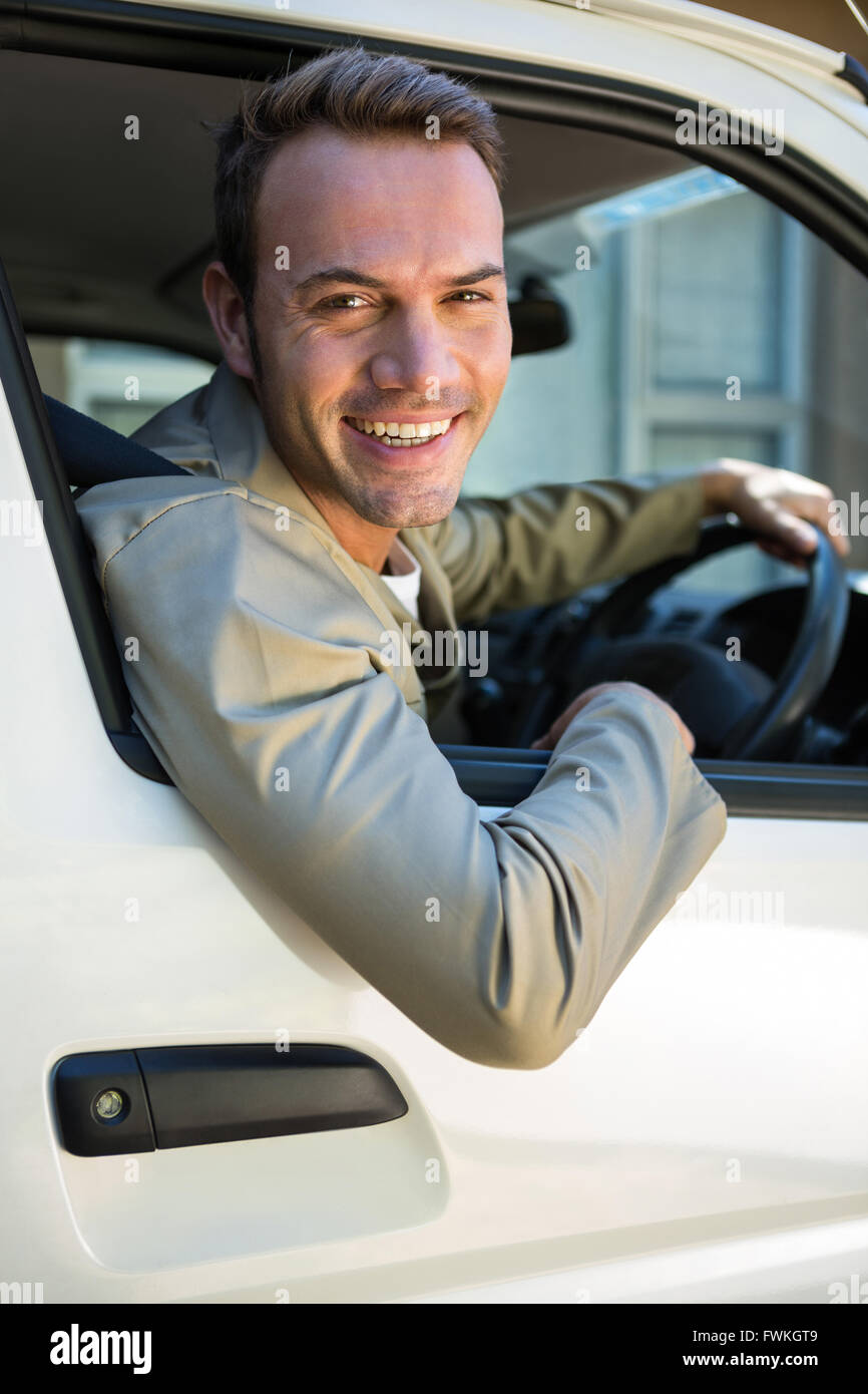 Delivery man driving in his van Stock Photo - Alamy