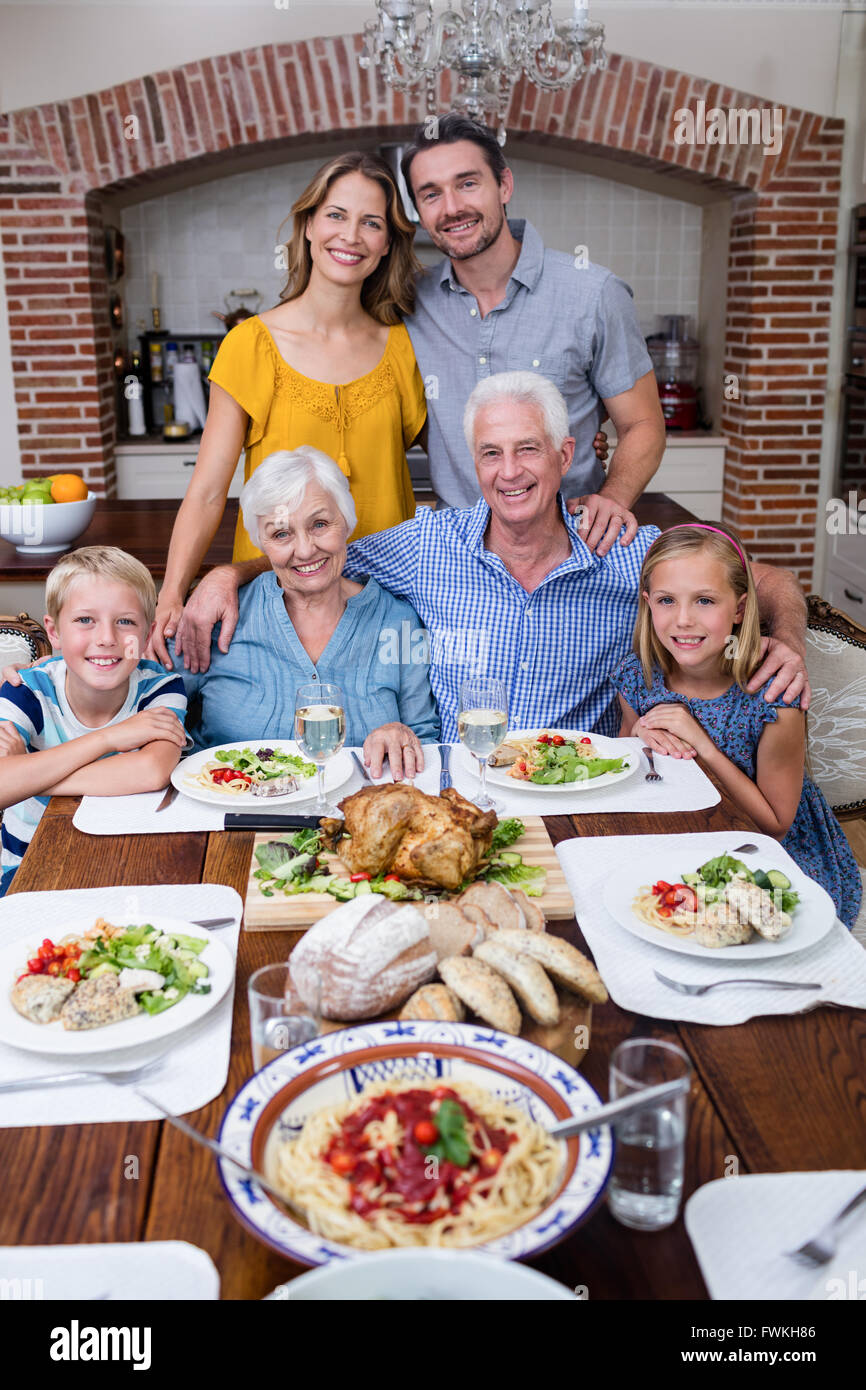 Multi generation family sitting around table hi-res stock photography ...