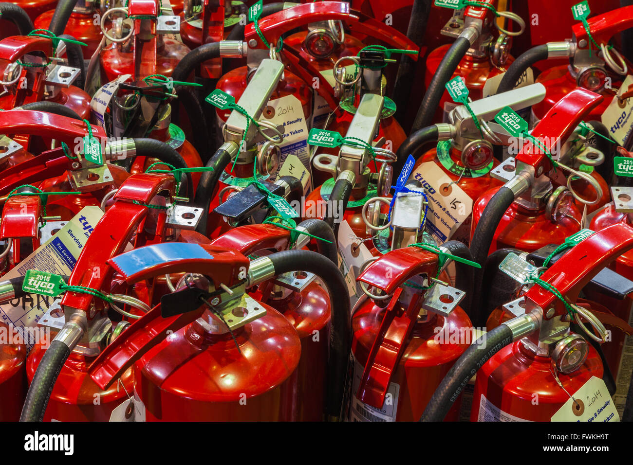 Several sizes of fire extinguishers awaiting deployment Stock Photo - Alamy