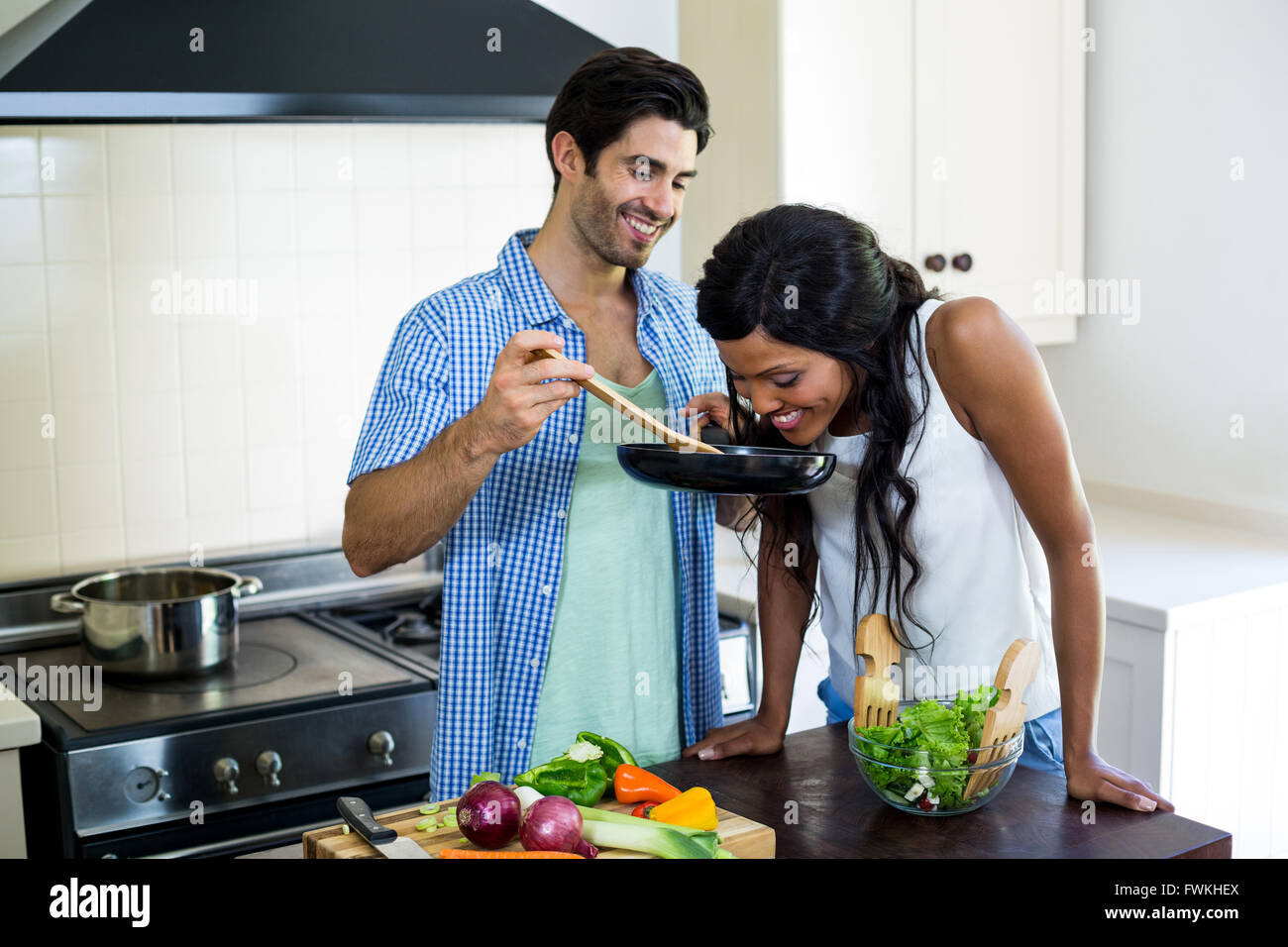 Young couple cooking food together in kitchen Stock Photo - Alamy