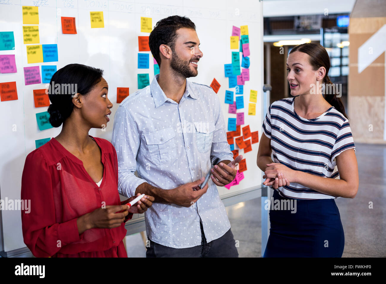 Colleagues discussing in the office Stock Photo - Alamy