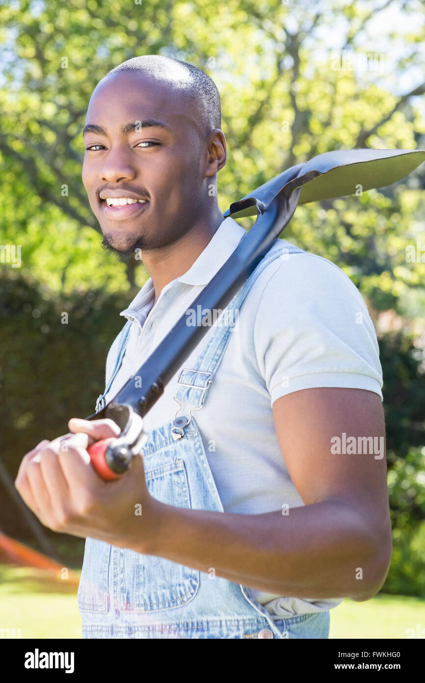 Young man posing with a shovel Stock Photo - Alamy