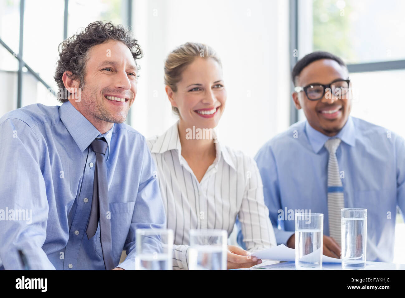 Businesspeople smiling in meeting Stock Photo - Alamy