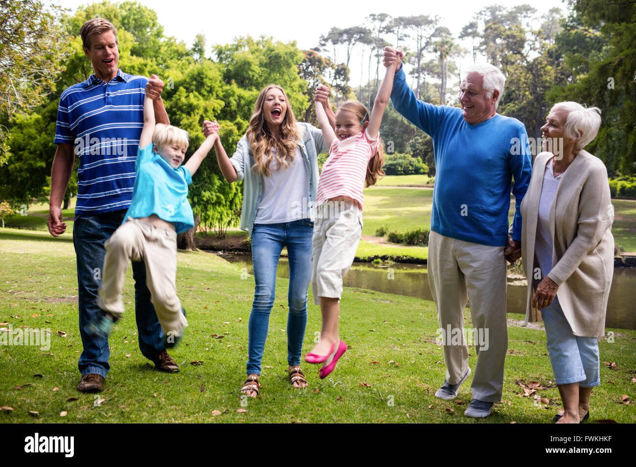 Multi-generation having fun in the park Stock Photo - Alamy