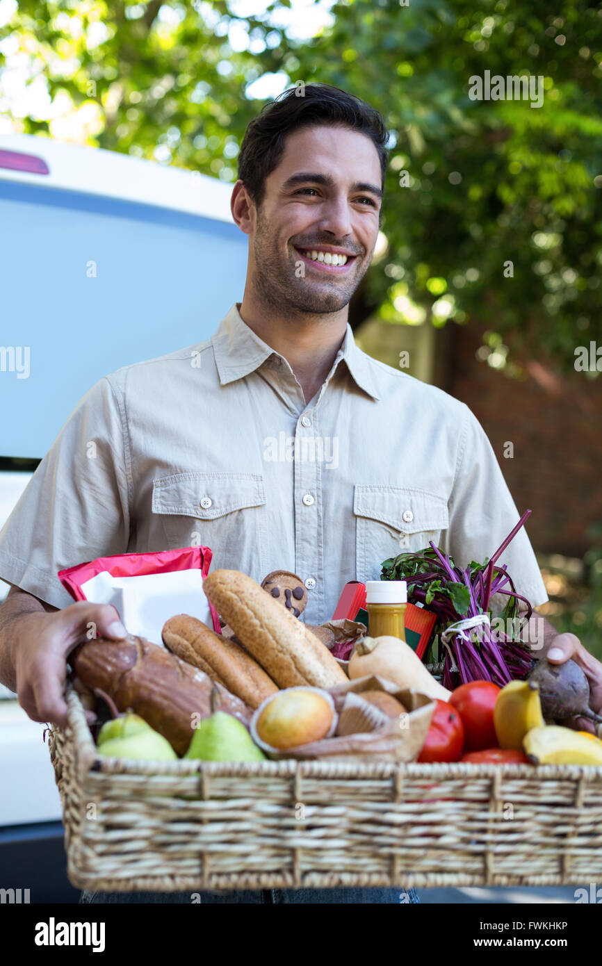 Delivery man carrying package Stock Photo - Alamy