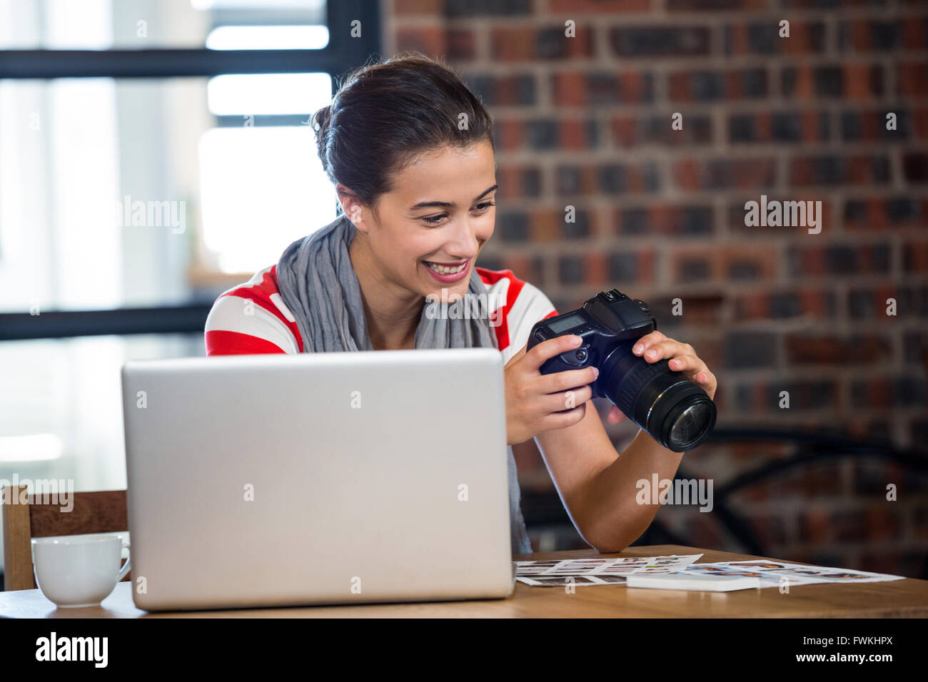 Woman checking photo in camera Stock Photo - Alamy