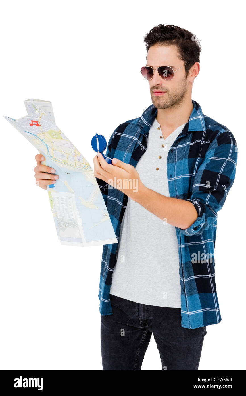 Young man in sunglasses looking at map and compass Stock Photo - Alamy