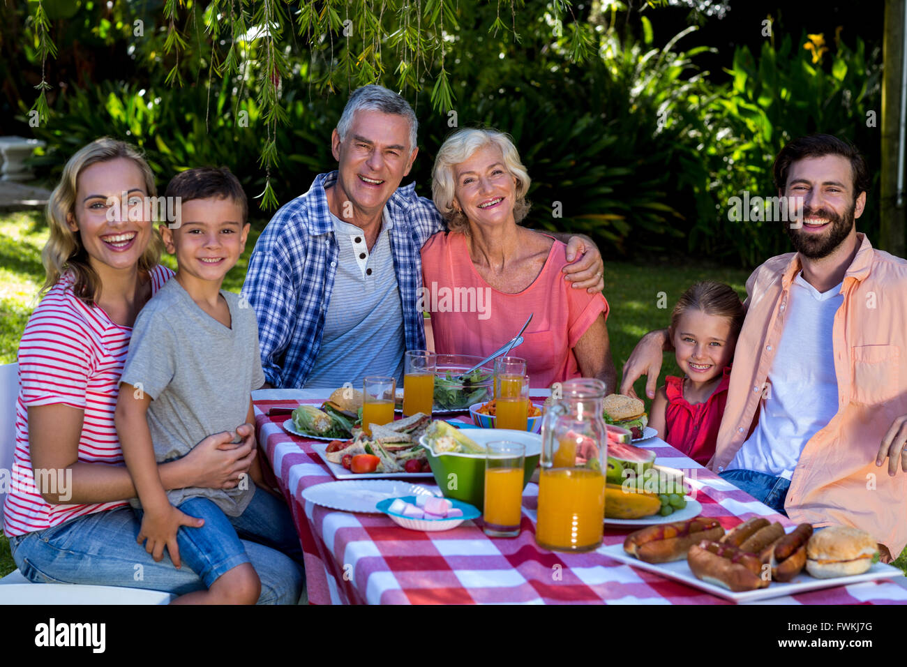 Multi-generation family enjoying breakfast in yard Stock Photo - Alamy