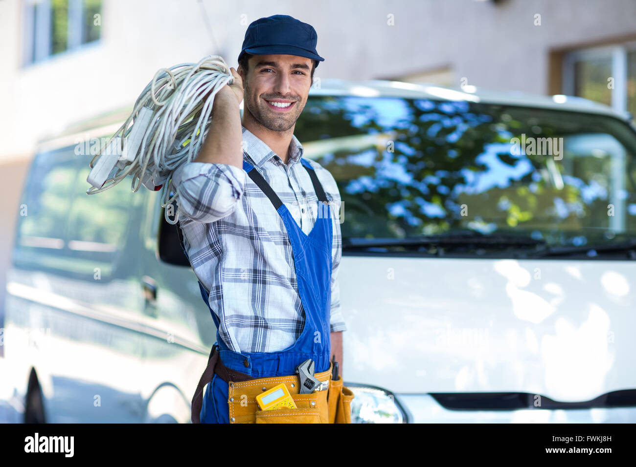 Portrait of happy carpenter with wire Stock Photo - Alamy