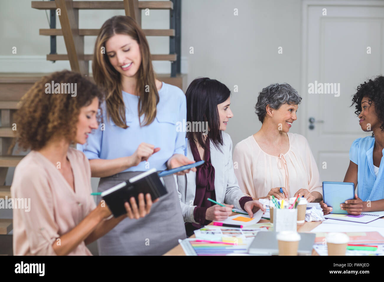 Group of interior designers interacting with each other Stock Photo - Alamy