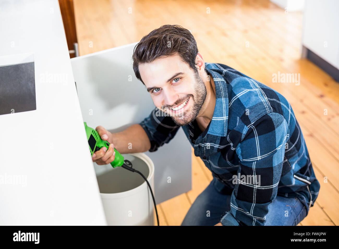 Man fixing kitchen sink Stock Photo - Alamy