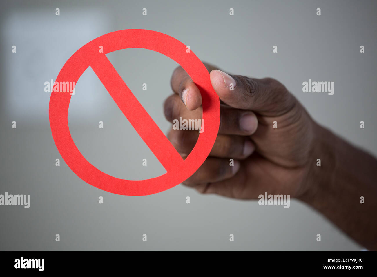 Hand holding a prohibition sign Stock Photo - Alamy