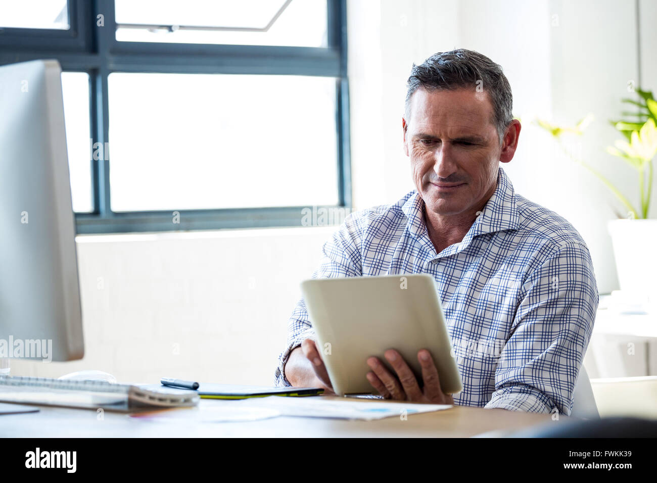 Happy man using digital tablet Stock Photo - Alamy