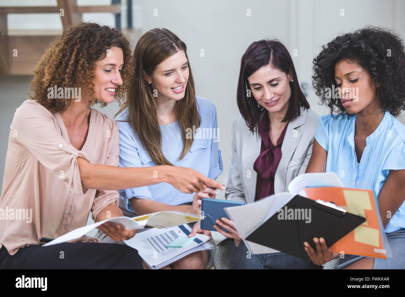Female business colleagues interacting with each other Stock Photo - Alamy