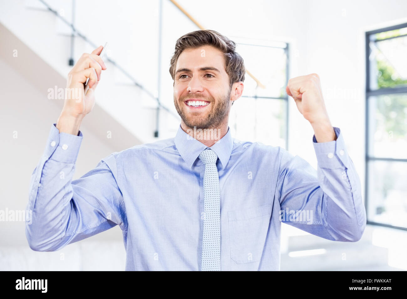 Excited businessman in office Stock Photo - Alamy