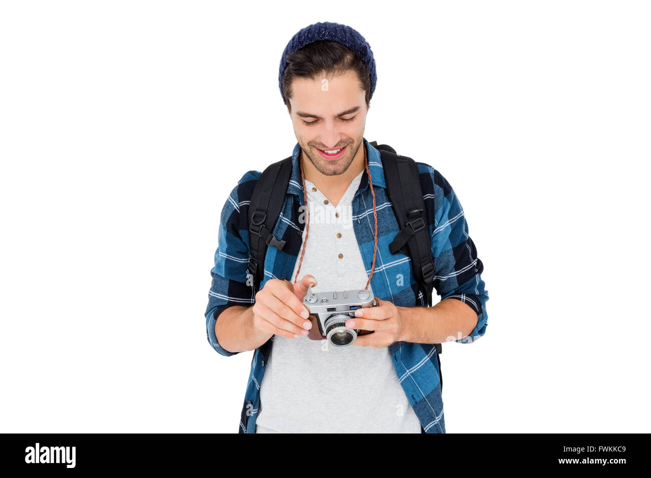 Young man carrying rucksack and using camera Stock Photo - Alamy