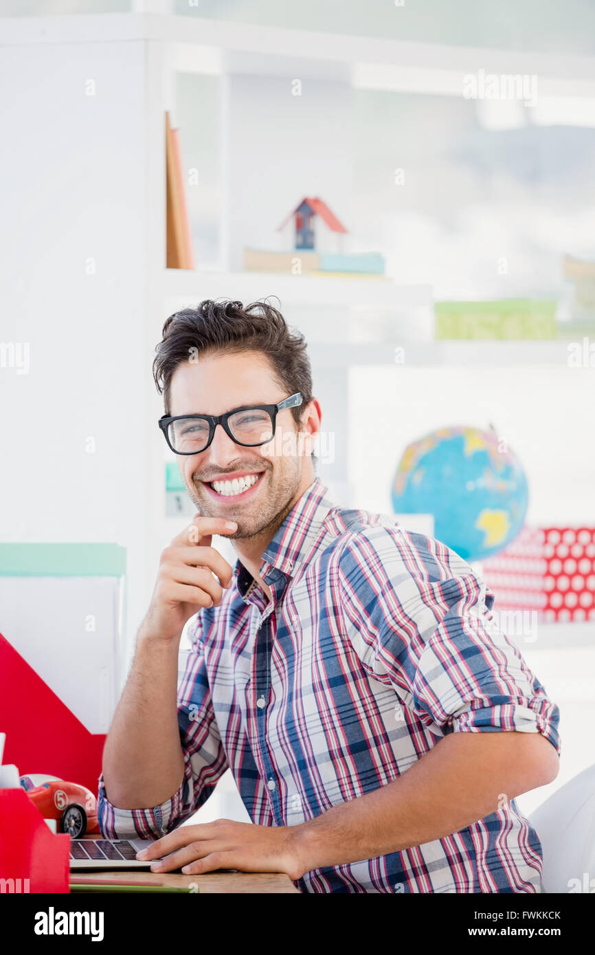 Young man sitting at his desk Stock Photo - Alamy