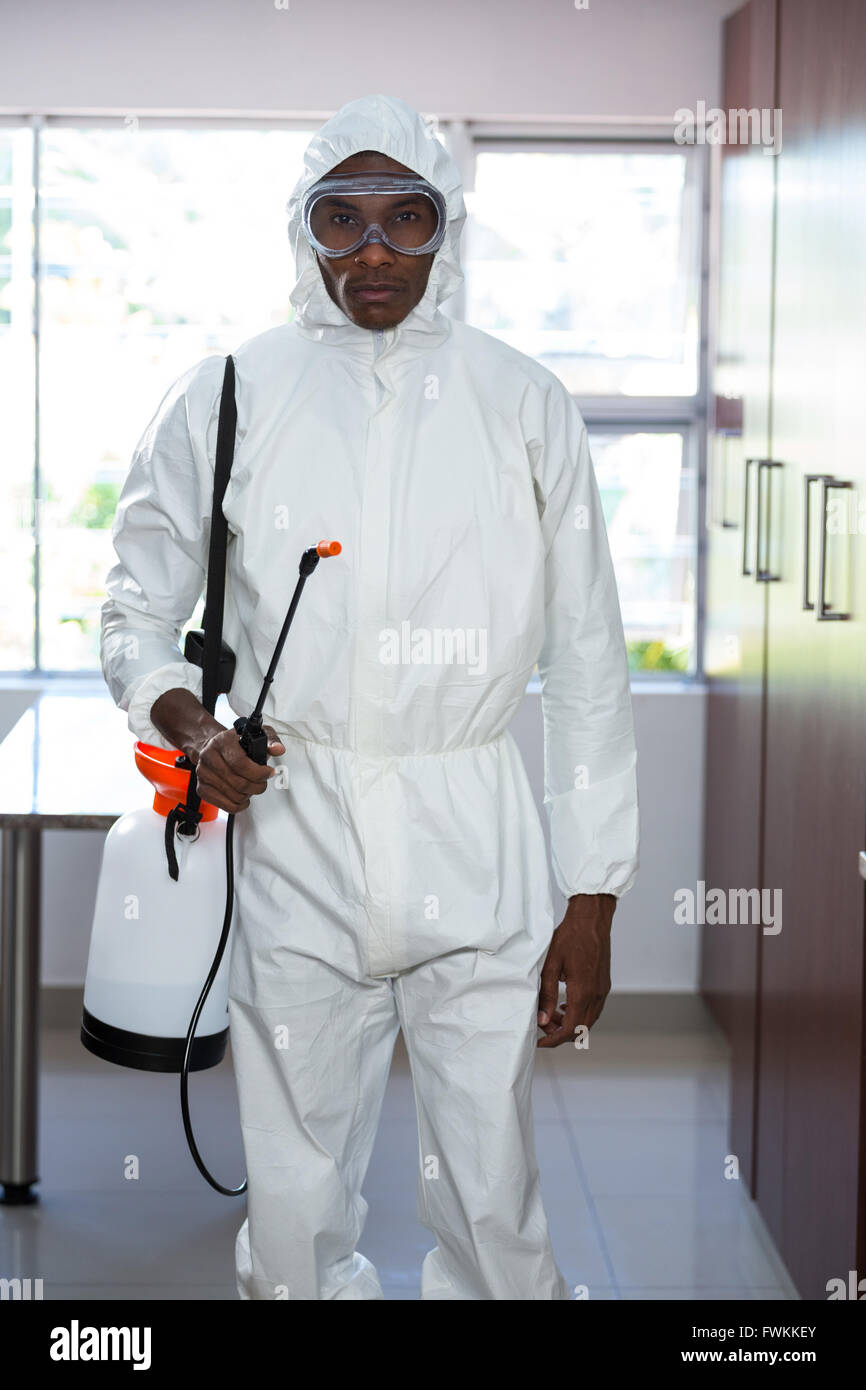 Portrait of pest control man standing with insecticide sprayer Stock ...