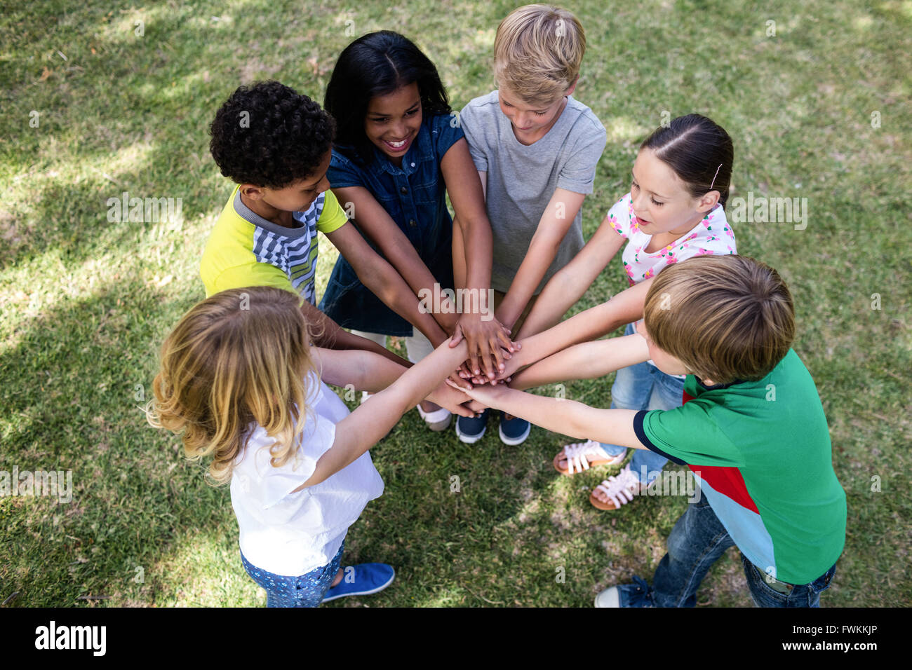 Children putting their hands together Stock Photo - Alamy
