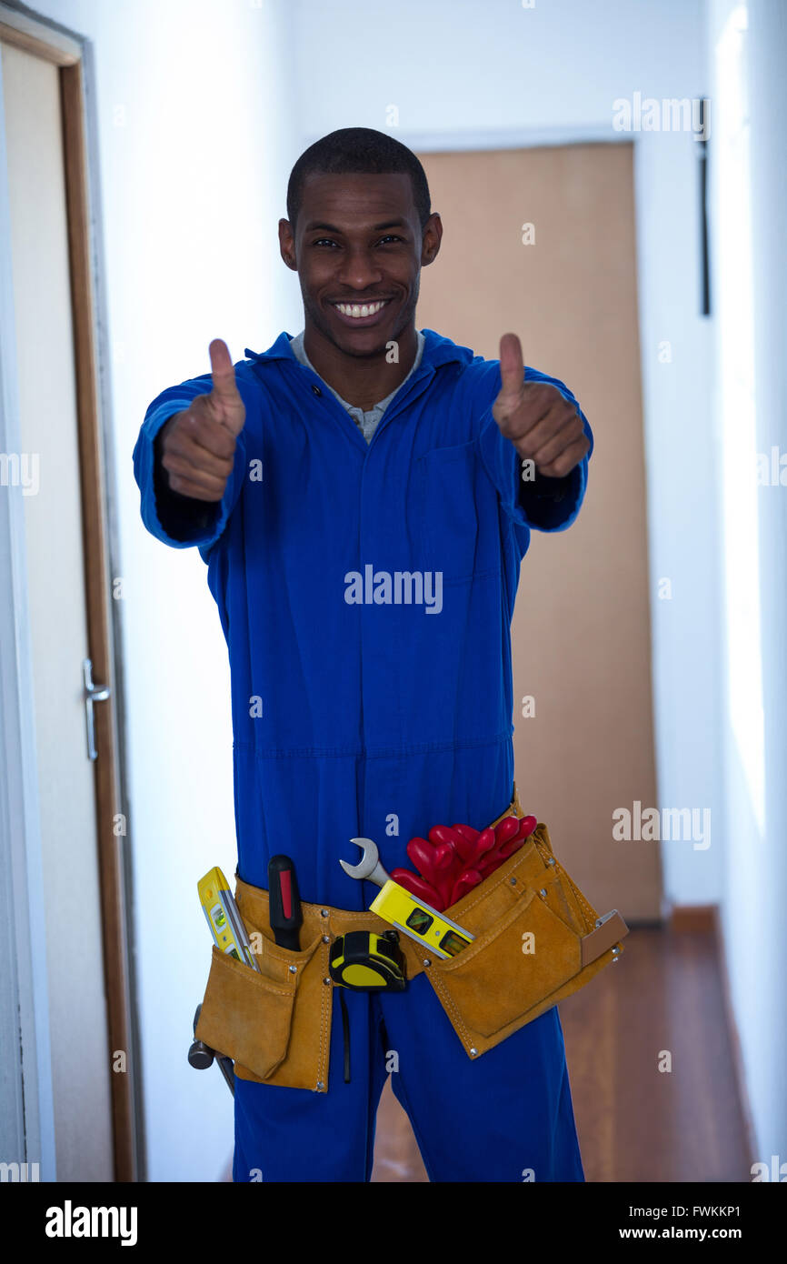 Happy handy man showing his thumbs up Stock Photo - Alamy