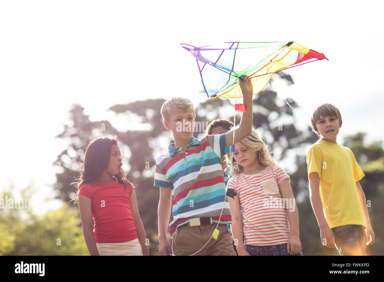 Happy children playing with a kite Stock Photo - Alamy