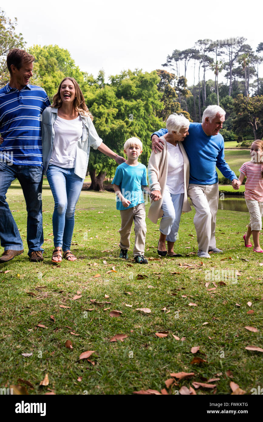 Multi-generation family walking in the park Stock Photo - Alamy