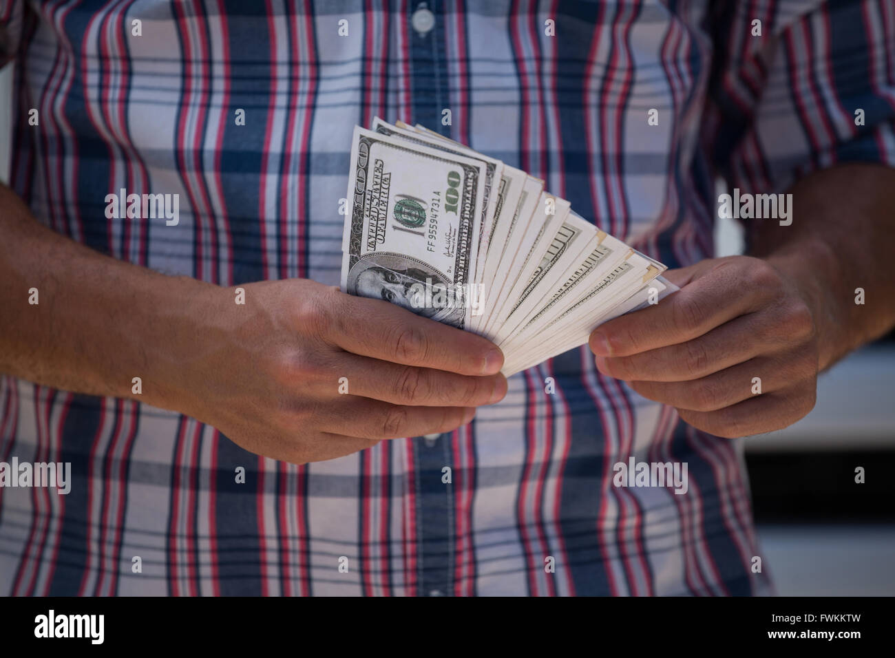 Rich man counting out his money hi-res stock photography and images - Alamy