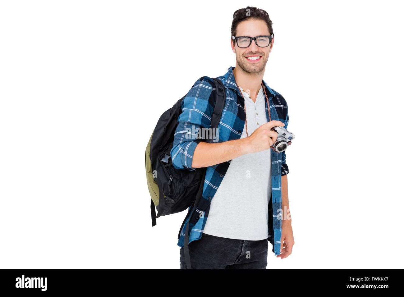 Young man carrying rucksack and holding camera Stock Photo - Alamy