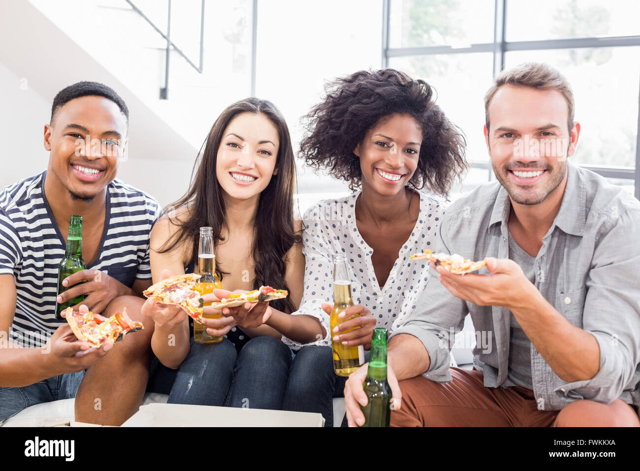 Friends having a pizza Stock Photo - Alamy