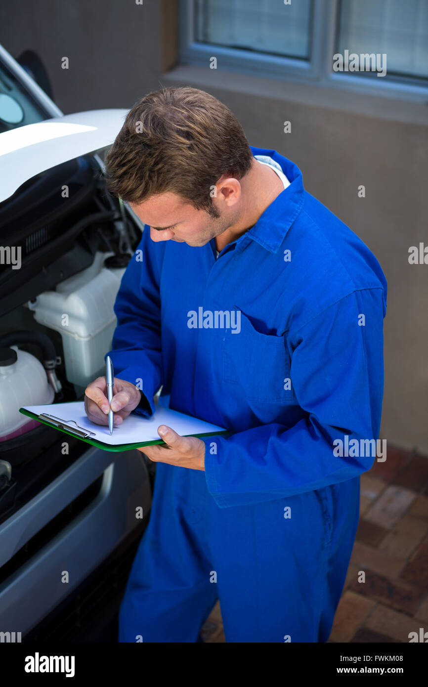 Mechanic preparing a check list Stock Photo - Alamy