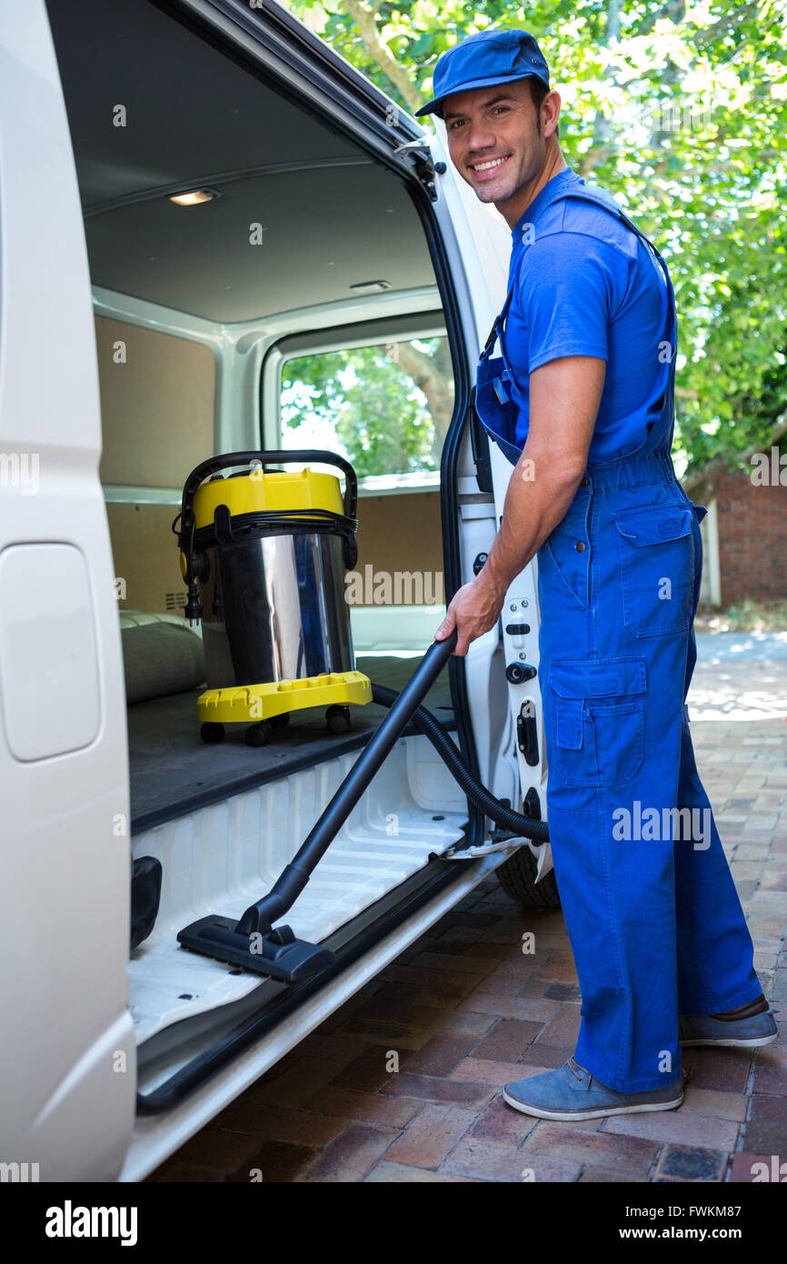 Happy janitor cleaning the car Stock Photo - Alamy