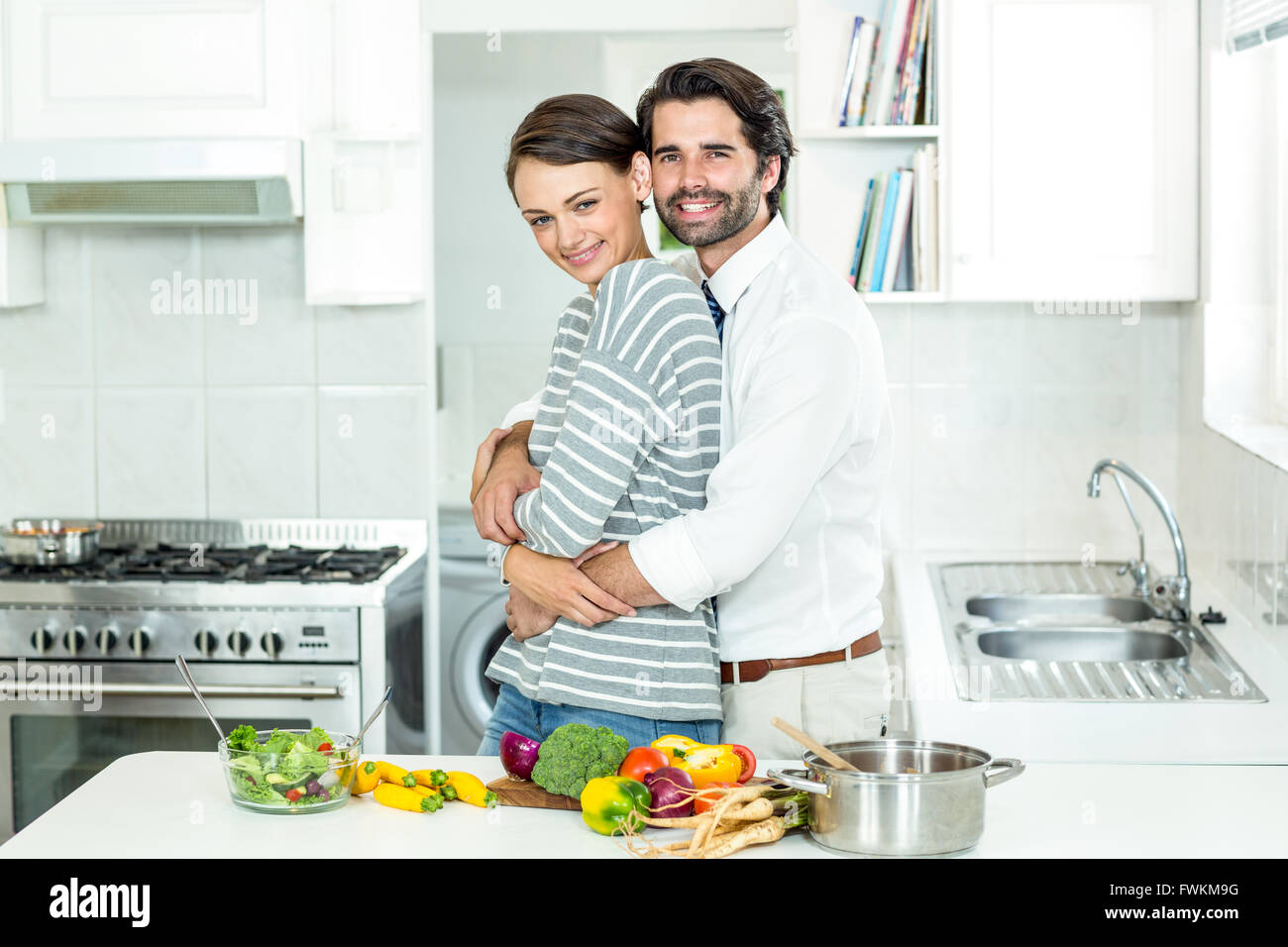 Couple hugging at kitchen sink hi-res stock photography and images - Alamy