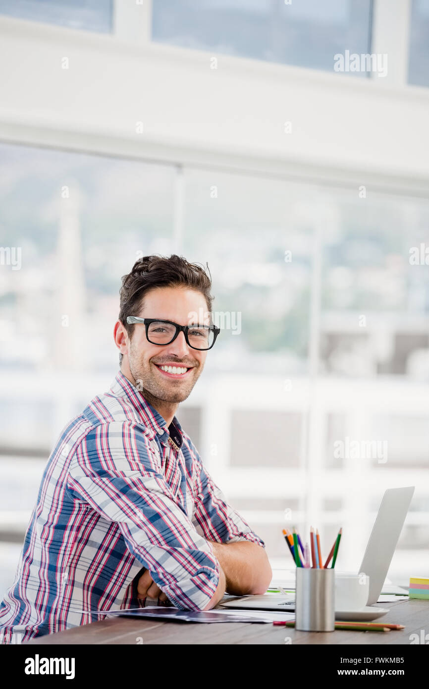 Young man sitting at his desk Stock Photo - Alamy