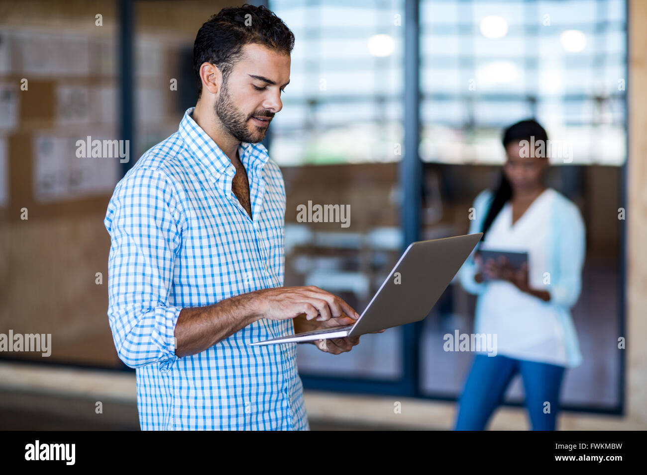 Young man using laptop Stock Photo - Alamy