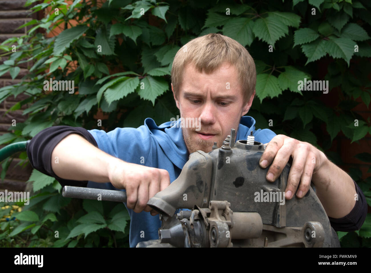 boy repairs motor scooter Stock Photo - Alamy boy repairs motor scooter Stock Photo - Alamy