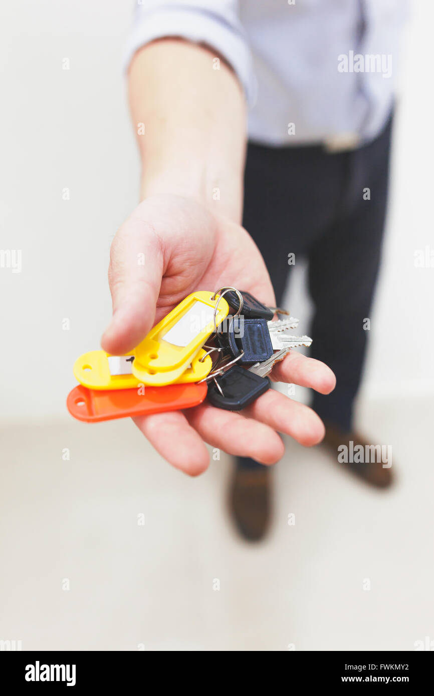 A man giving keys, vintage tone image Stock Photo - Alamy
