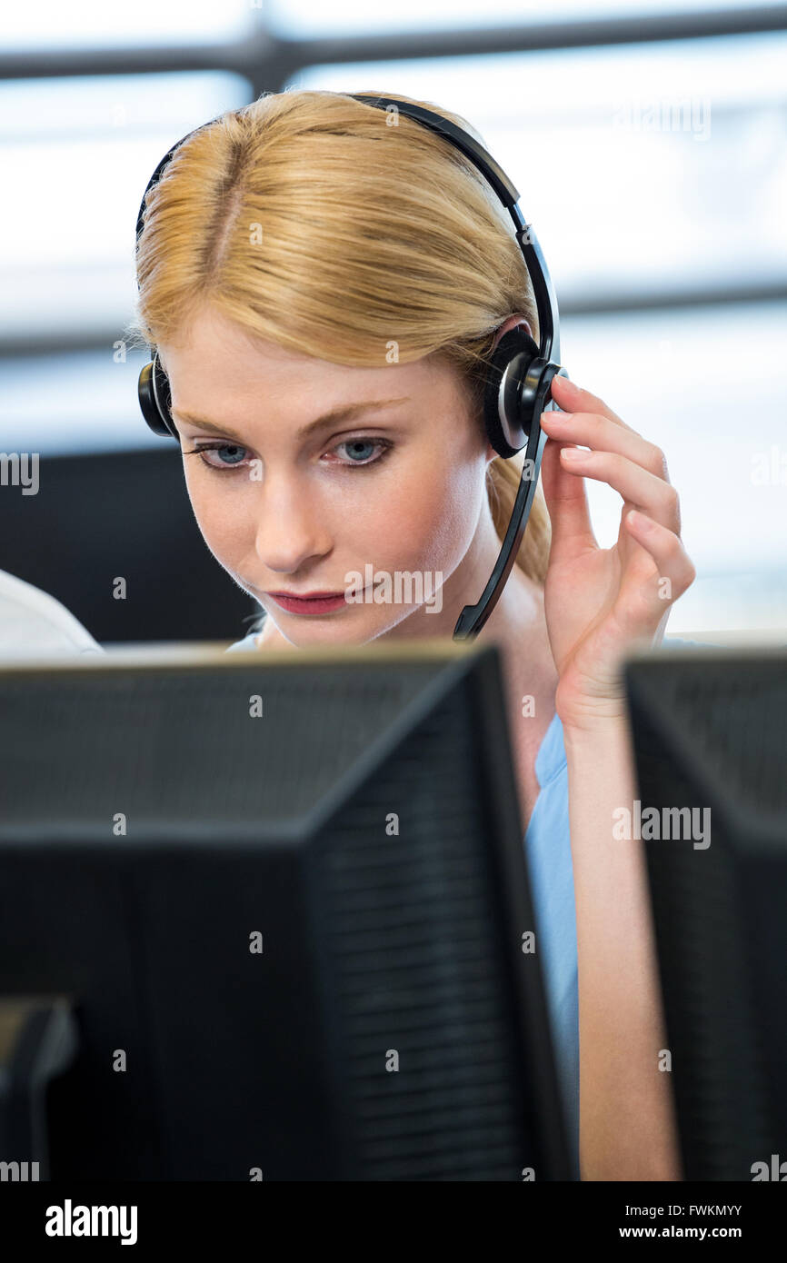 Woman working on computer with headset Stock Photo - Alamy