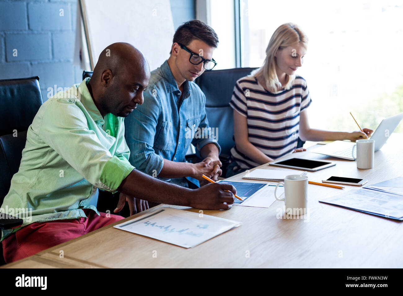 Colleagues working at their desk Stock Photo - Alamy