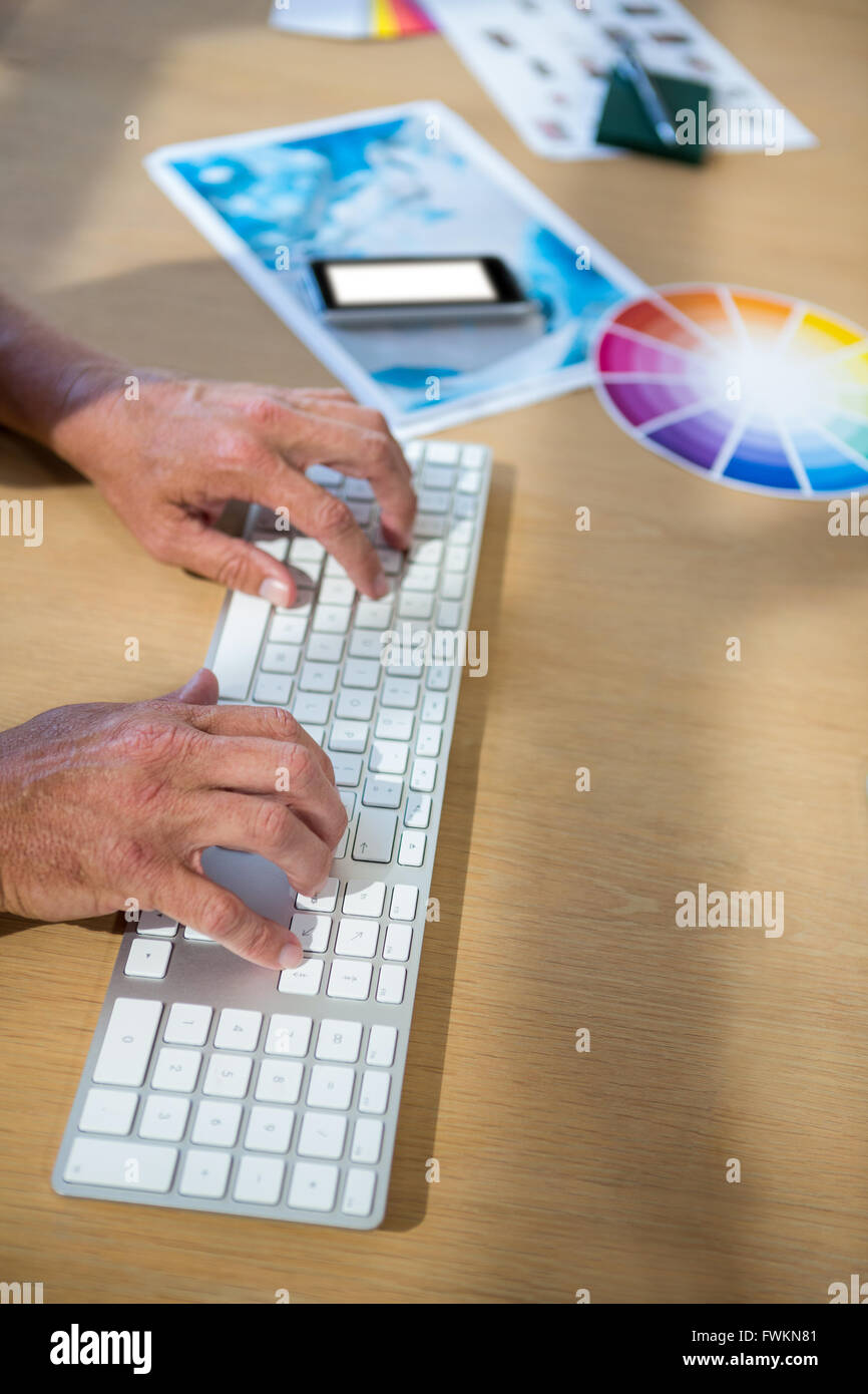 Graphic designer typing on keyboard Stock Photo - Alamy