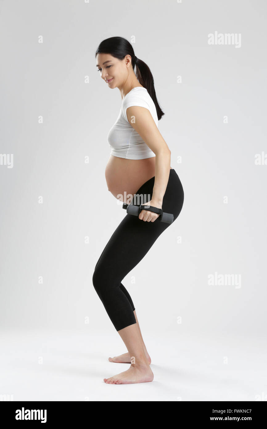 Pregnant woman doing fitness exercise Stock Photo - Alamy
