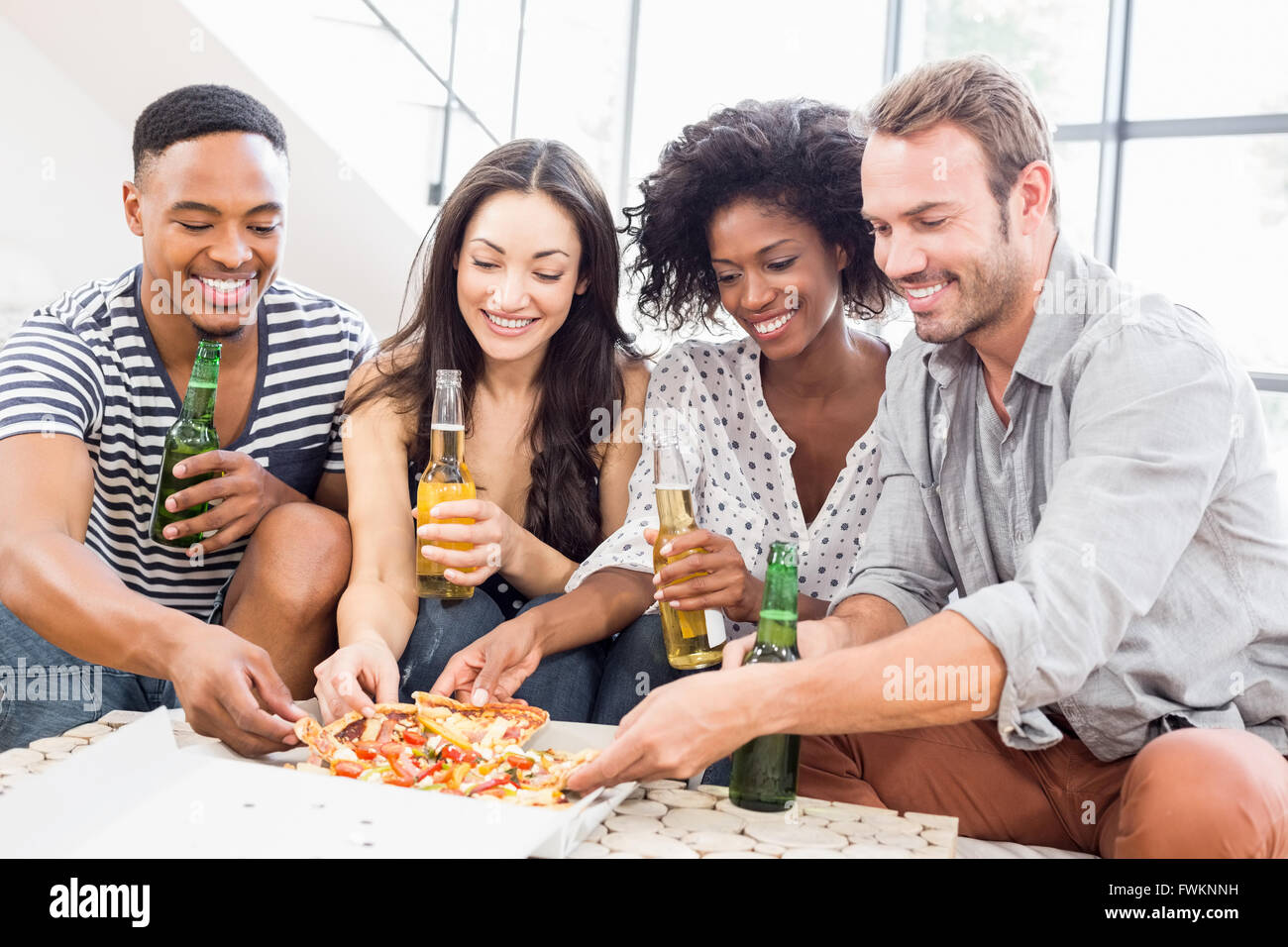 Friends having a pizza Stock Photo - Alamy