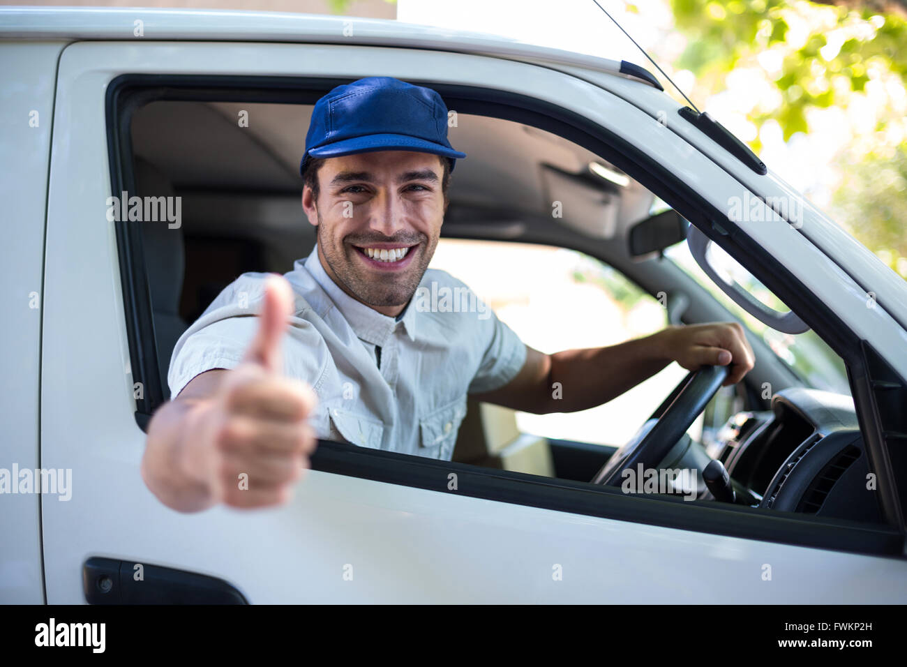 Delivery man sitting in his van Stock Photo - Alamy