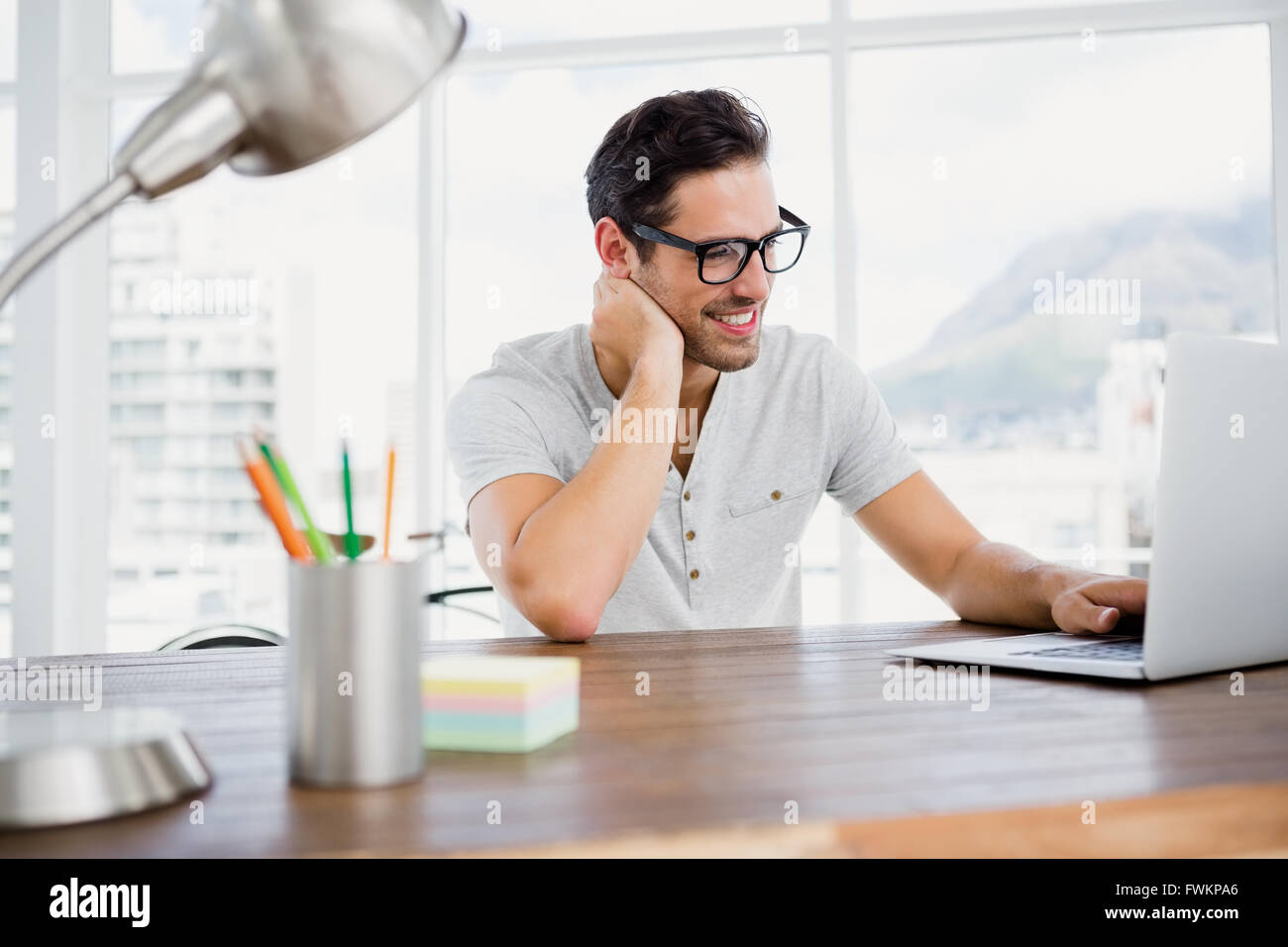 Young man working at his desk Stock Photo - Alamy
