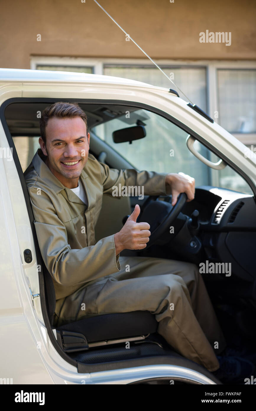 Delivery man sitting in his van Stock Photo - Alamy