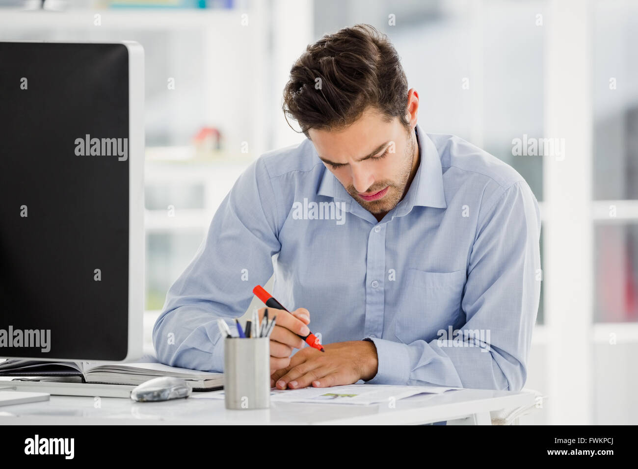 Businessman taking notes at his desk Stock Photo - Alamy