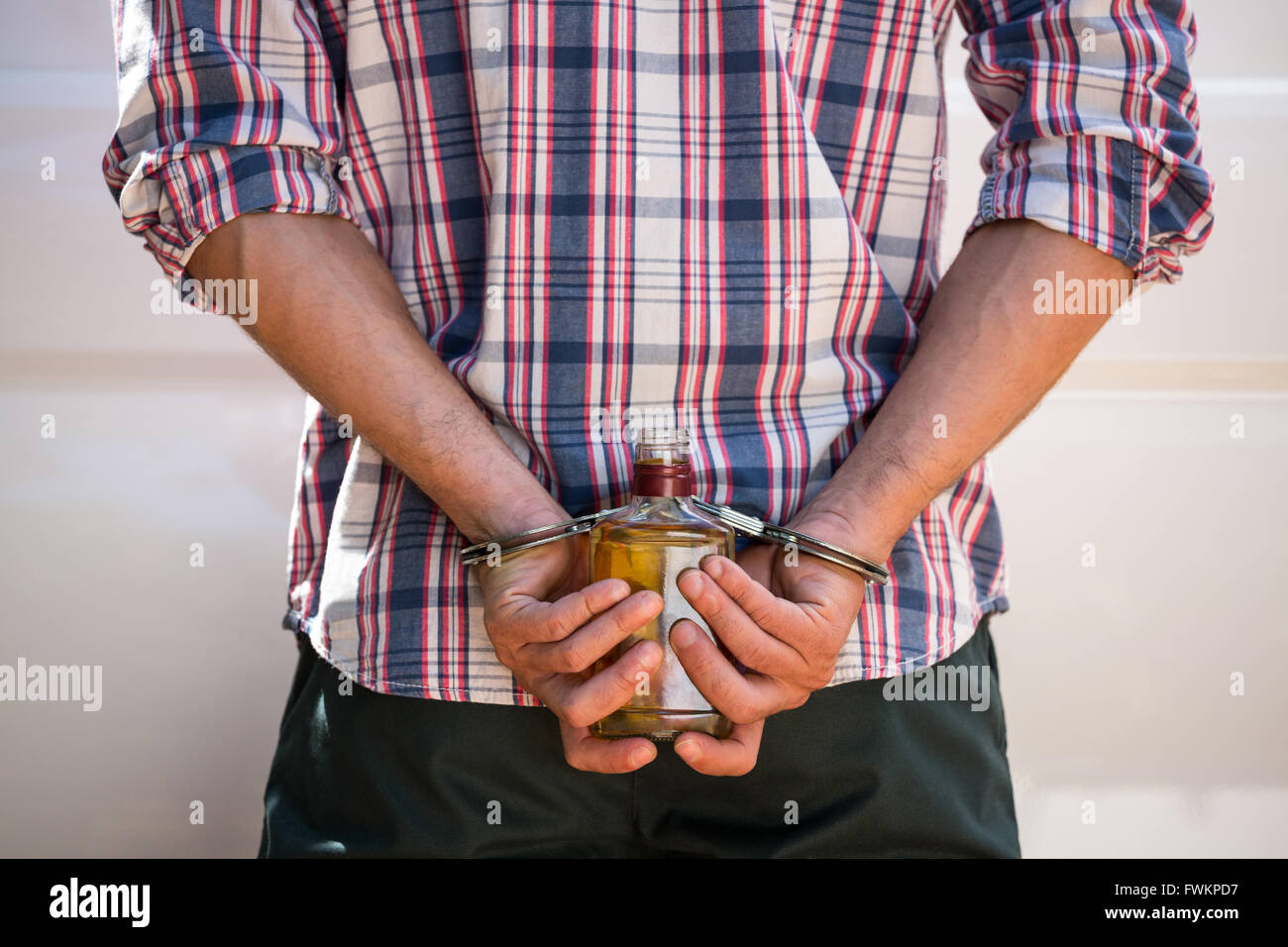 Man handcuffed behind his back Stock Photo - Alamy