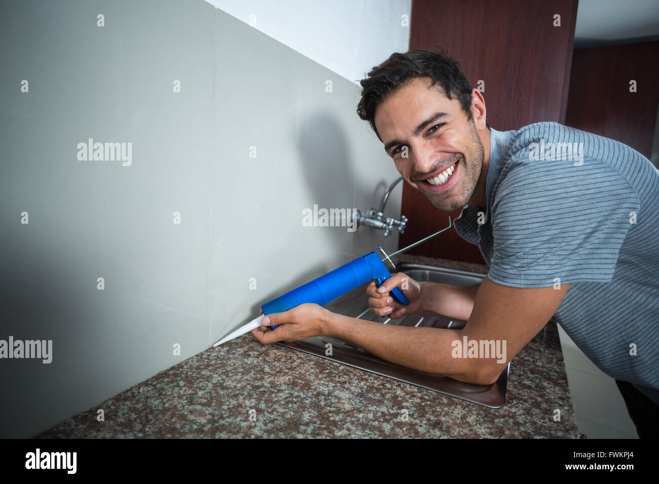 Portrait of happy man using pest control injection Stock Photo - Alamy